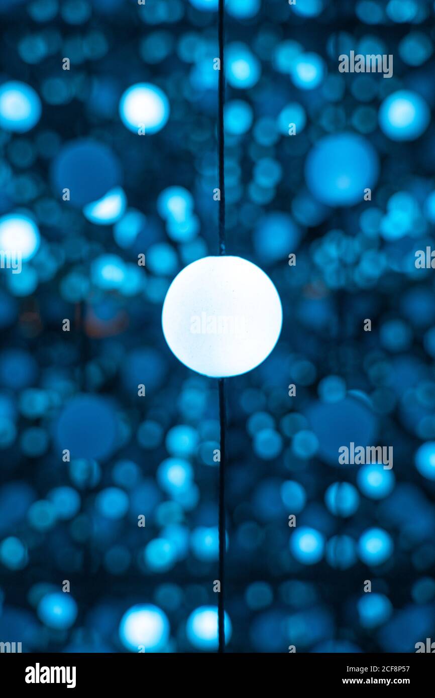 Background of glowing colorful blue lights with bright round bulb ...