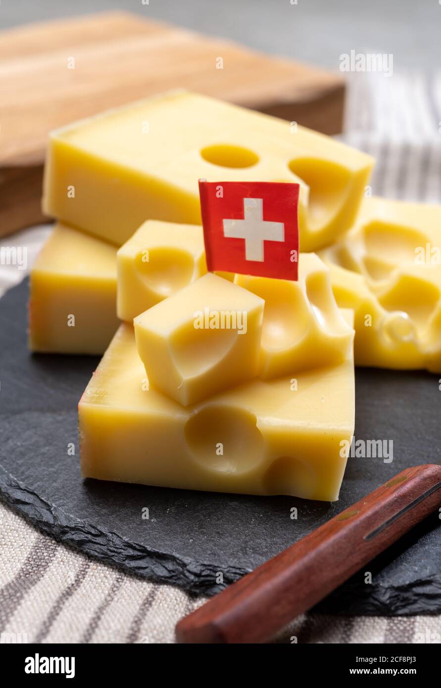 Block of Swiss medium-hard yellow cheese emmental or emmentaler with ...