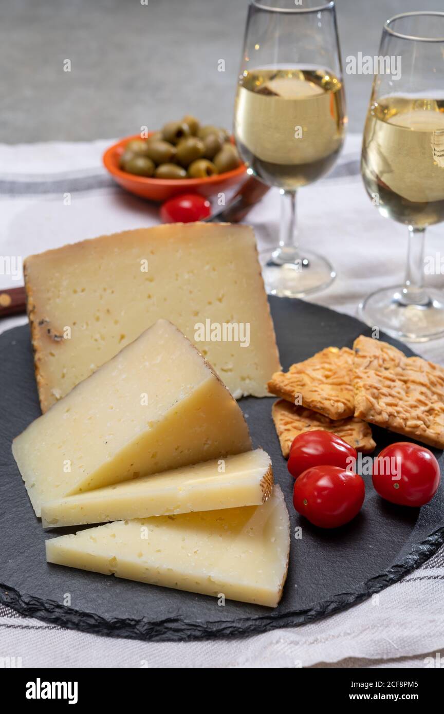 Spanish tapas, manchego cheese made, green olives served with glasses ...