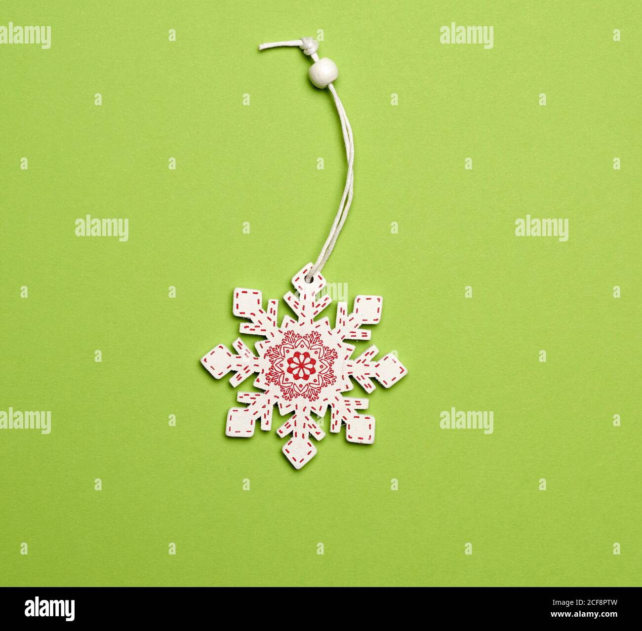 white wooden decorative snowflake on a green background, top view Stock ...