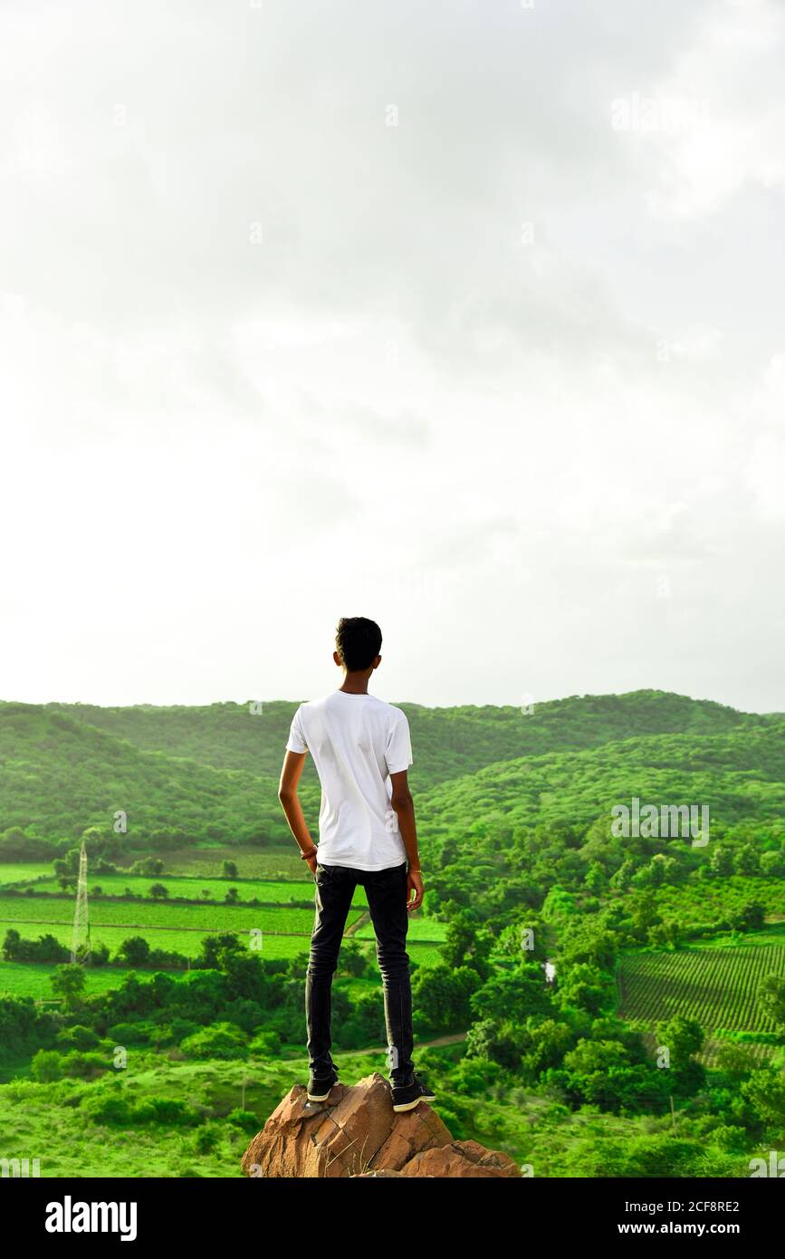 Man standing on top of mountain and watching nature greenery .Beautiful ...