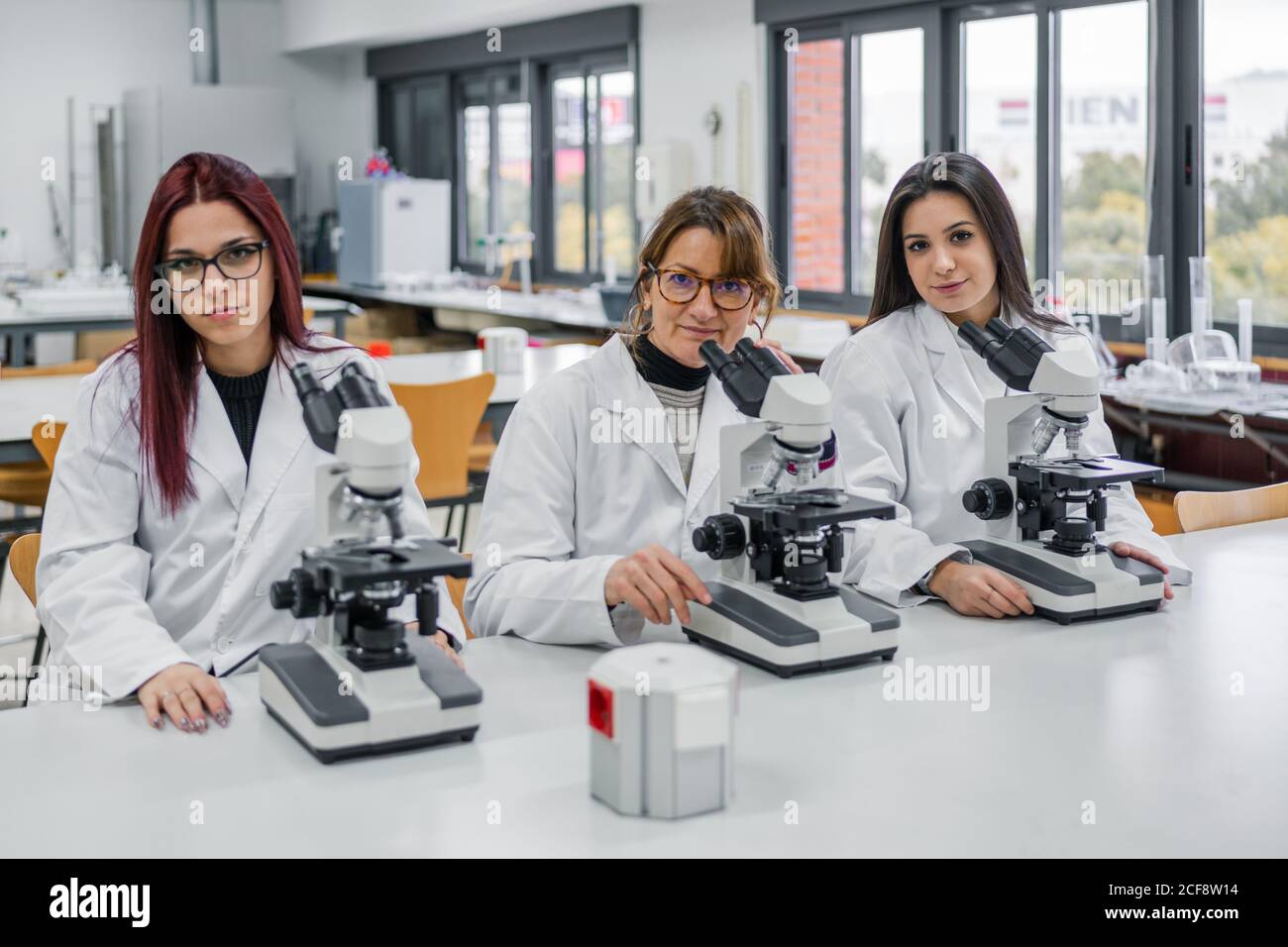 Female scientists using microscopes in lab Stock Photo - Alamy