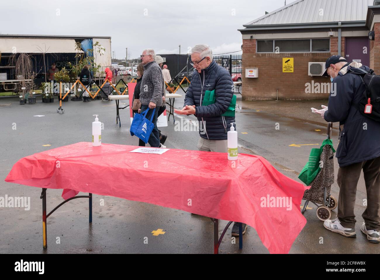 A person using hand sanitiser at the entrance to the Australian Capital ...