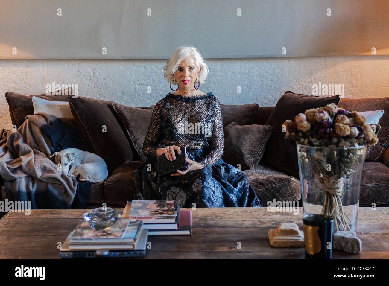 Gorgeous senior Woman in elegant black dress with leather handbag ...