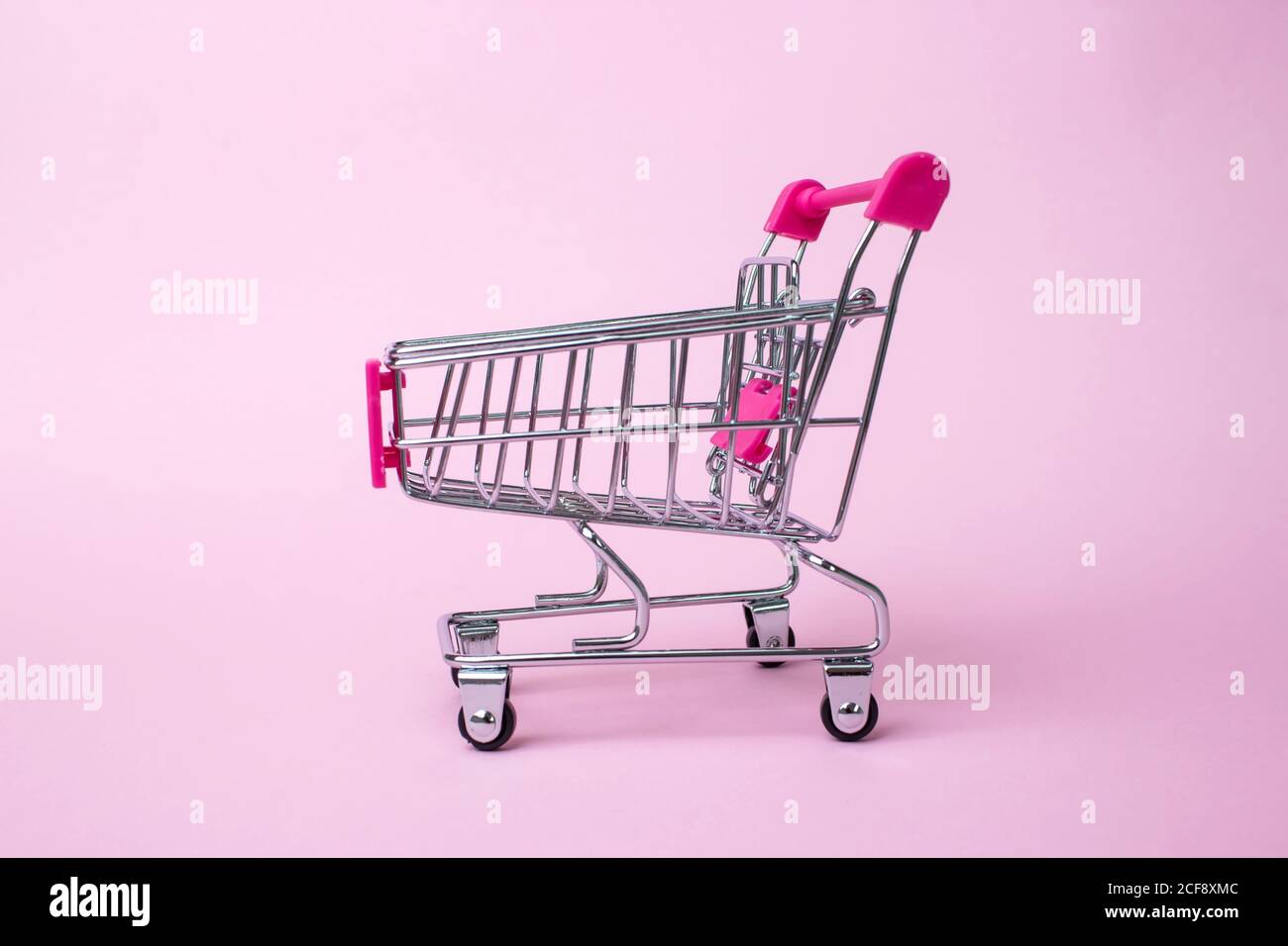 A Shopping Cart. Mini shopping trolley, on pink background. Mini ...