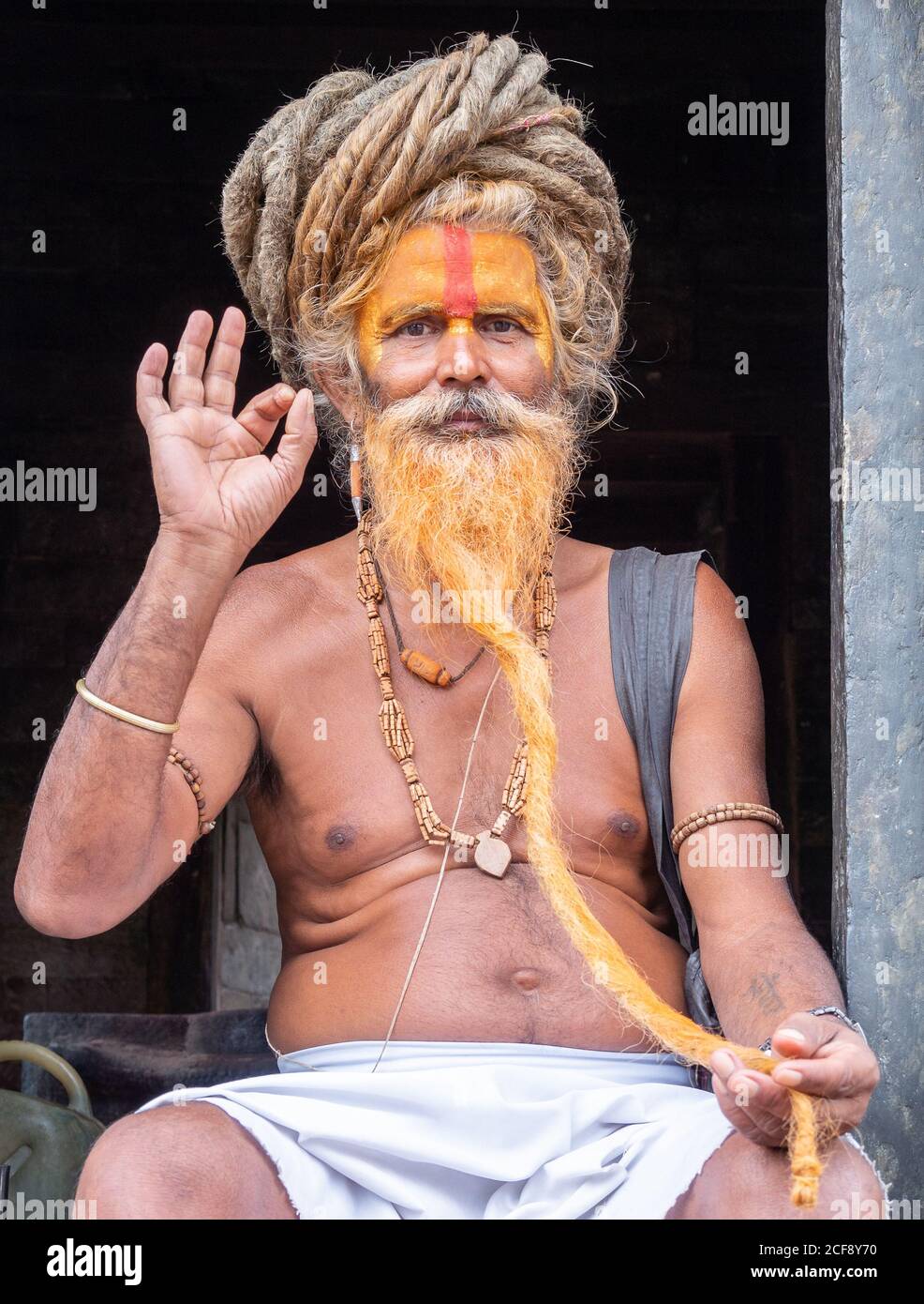 NEPAL, PASHUPATINATH TEMPLE - AUGUST 4, 2014: Aged shirtless sadhu with ...