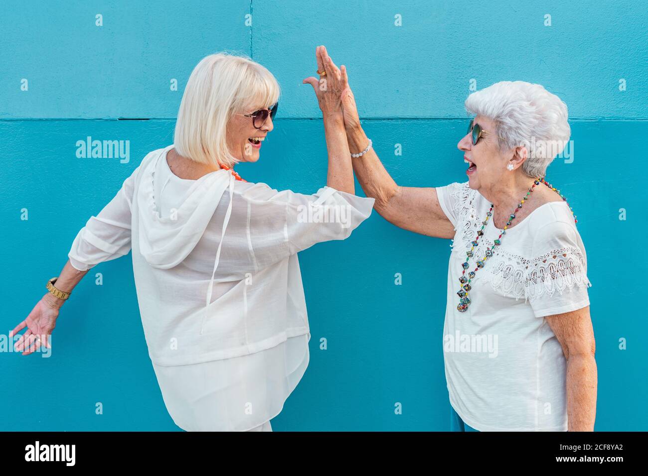Side view laughing modern cheerful elderly grey-haired women in ...