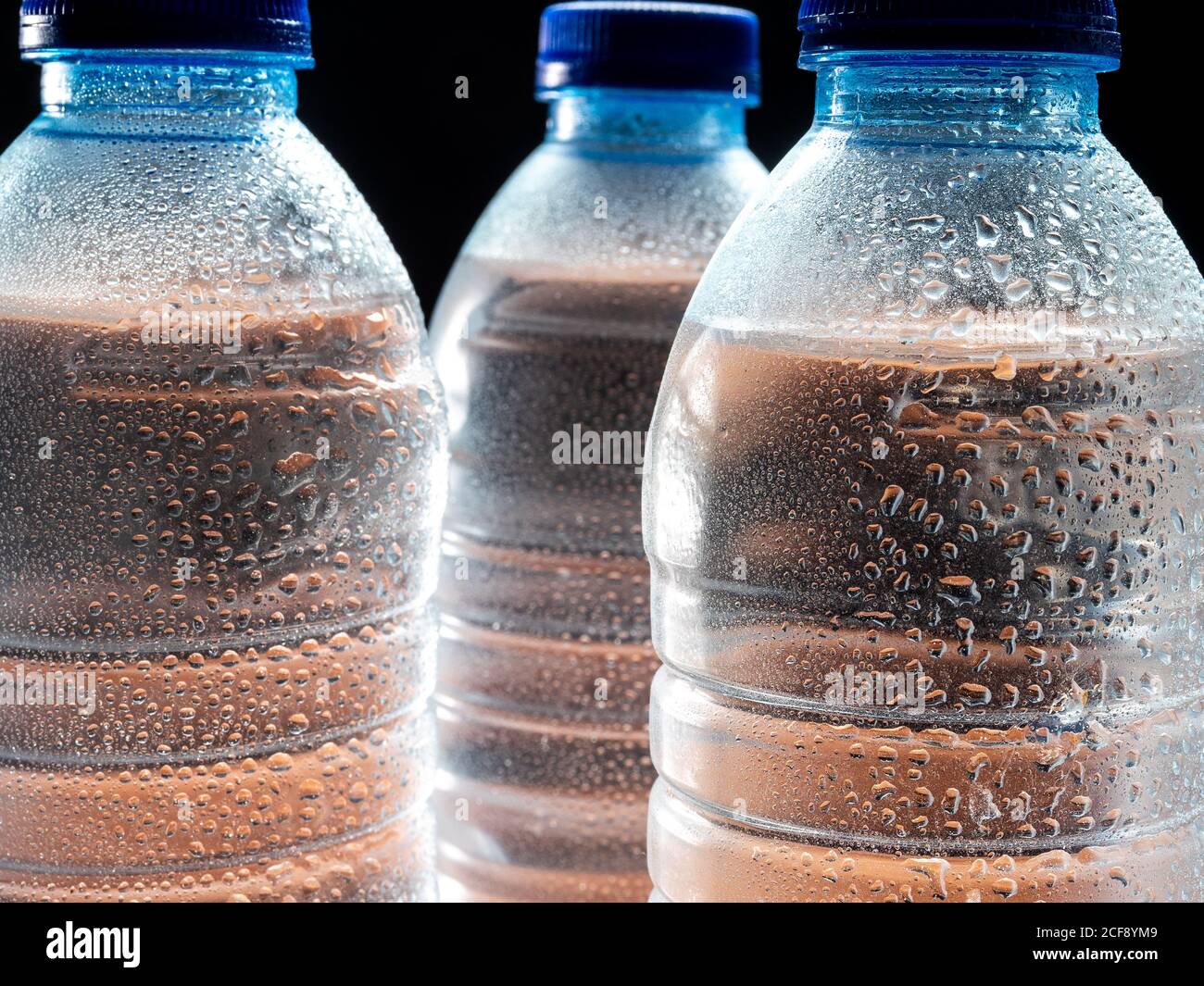 Group of very cold water bottles with blue caps and water drops Stock ...