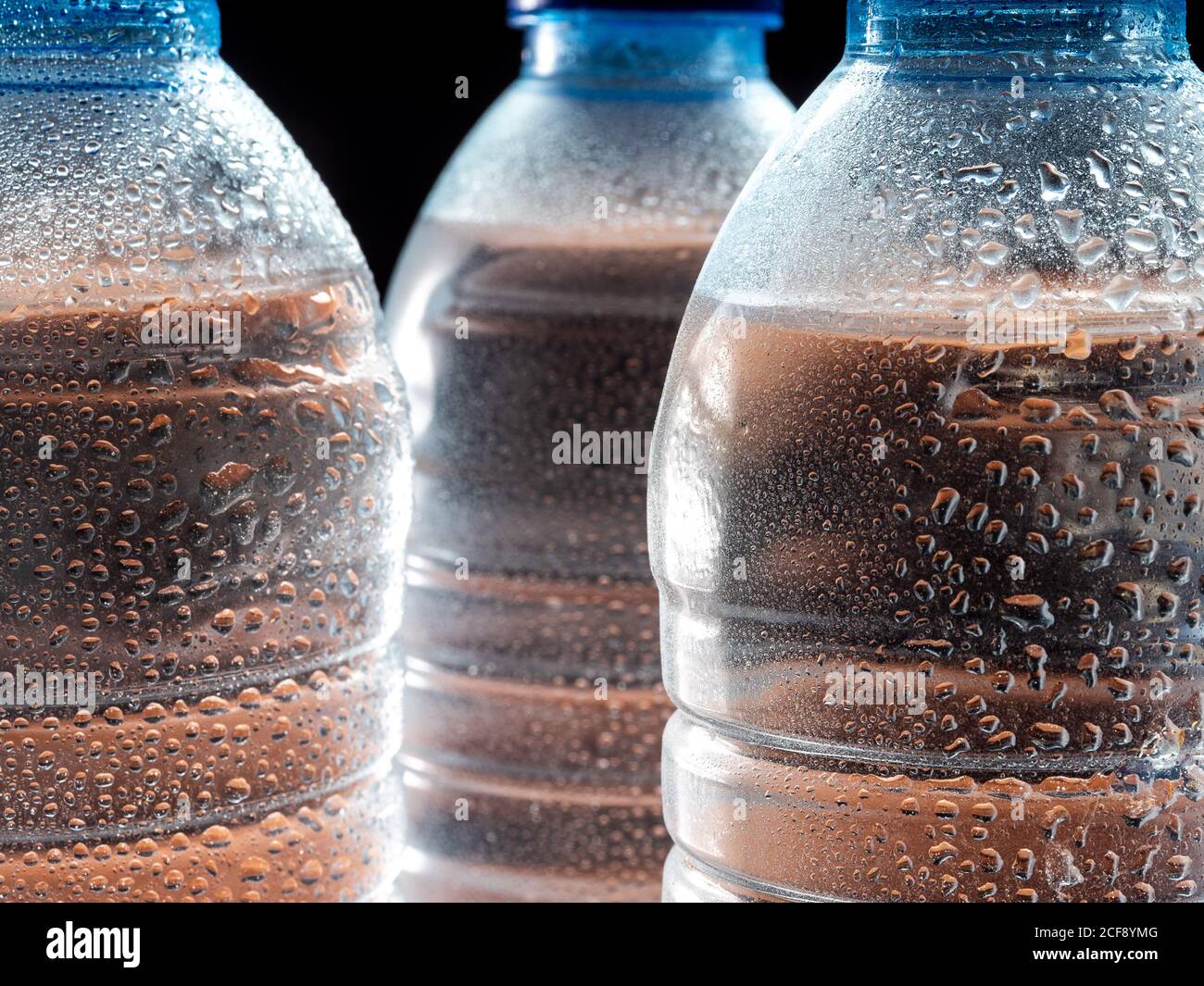 Group of very cold water bottles with blue caps and water drops Stock ...