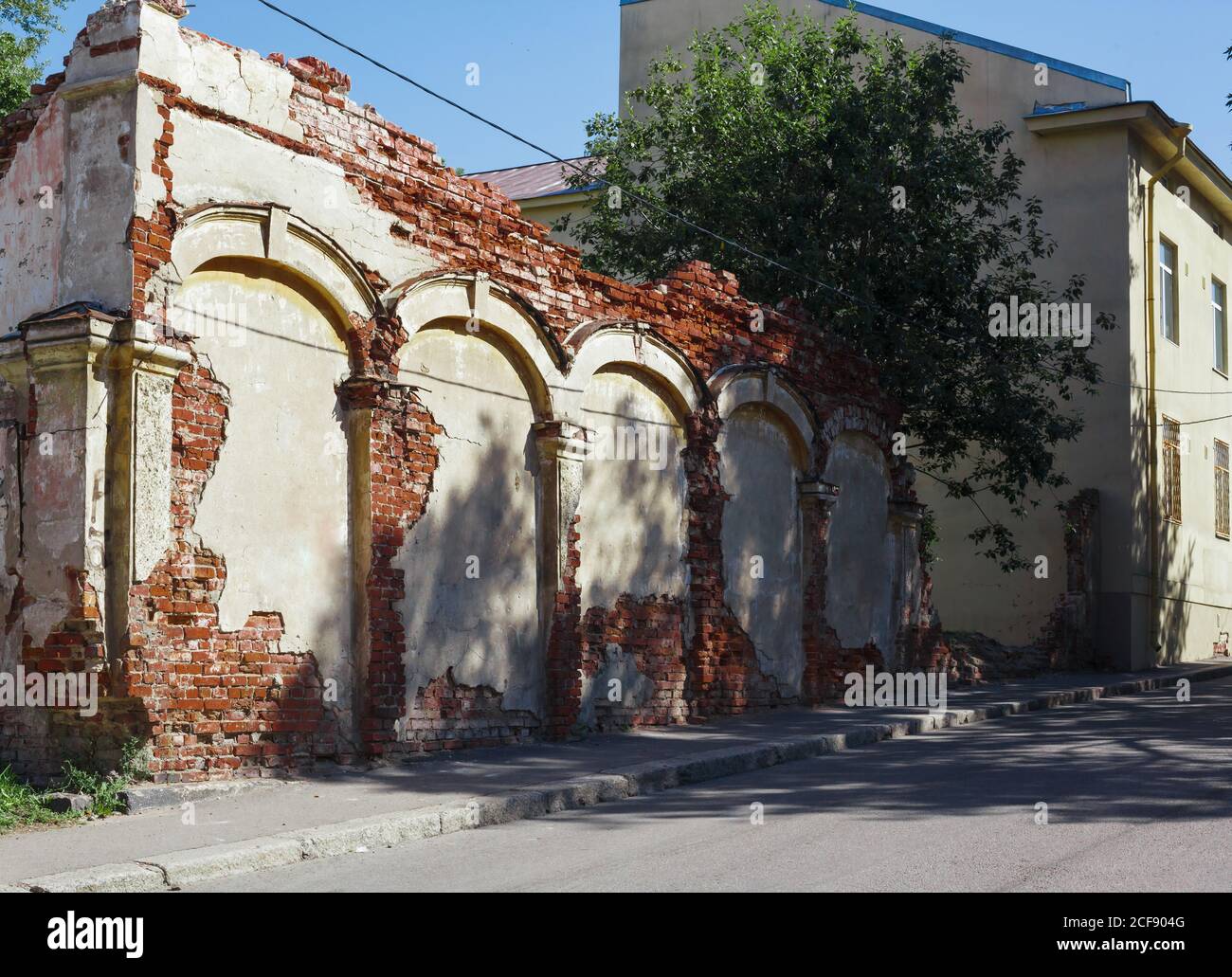 Ruined ancient house with arches and columns on the street of Vyborg ...