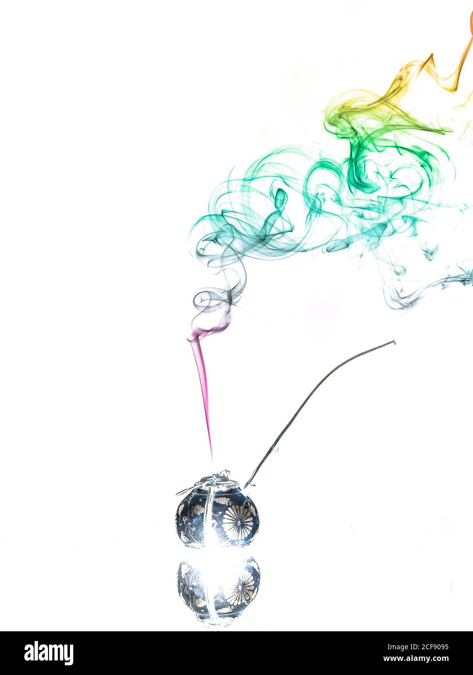 Jar with herbs emitting smoke Stock Photo - Alamy