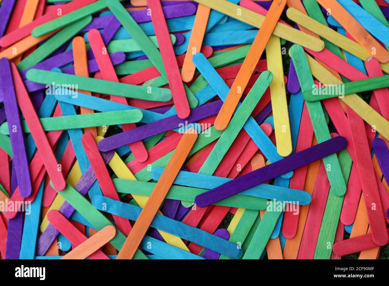 Multicolored popsicle sticks in bulk in shades of purple red light blue ...