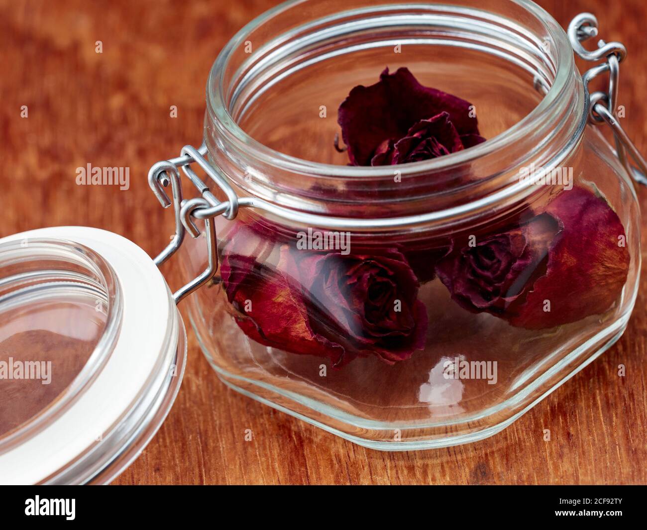 Glass jar filled with dried roses inside Stock Photo - Alamy
