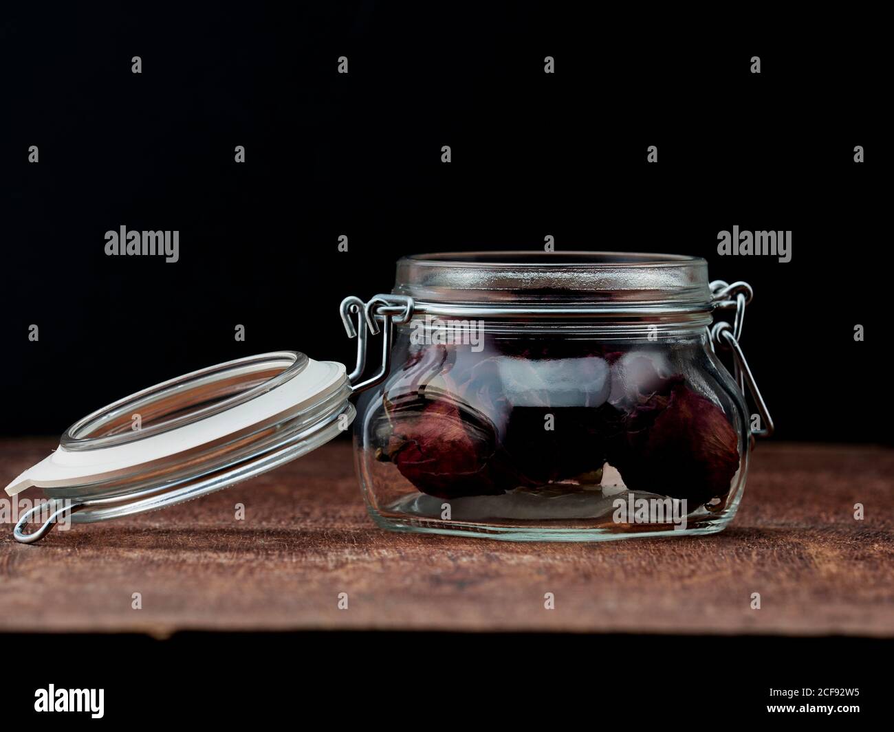 Glass jar filled with dried roses inside Stock Photo - Alamy