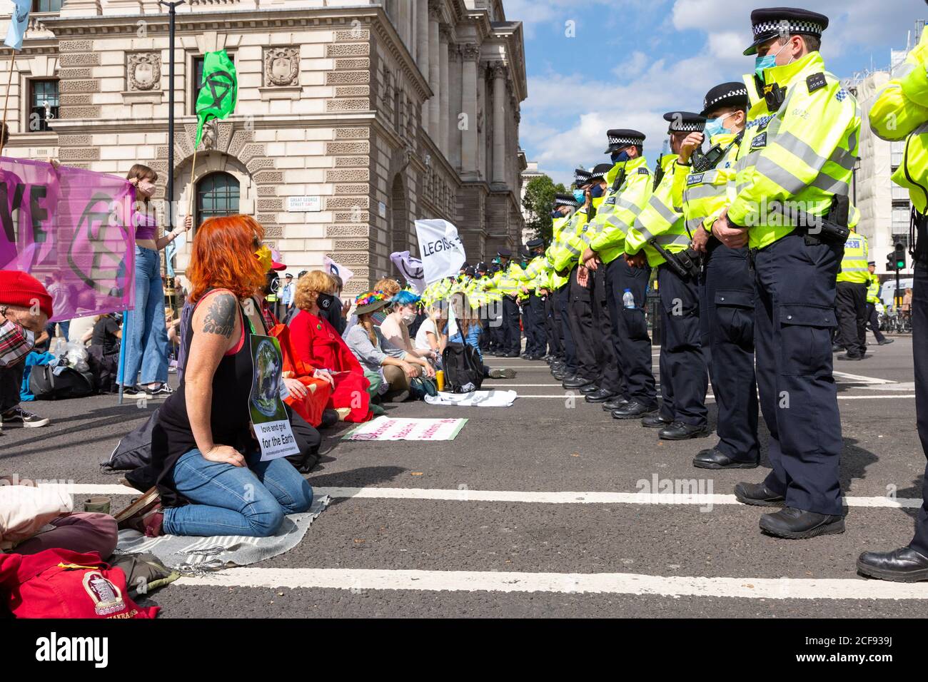 Protesters block a road in front of police line-up during Extinction ...