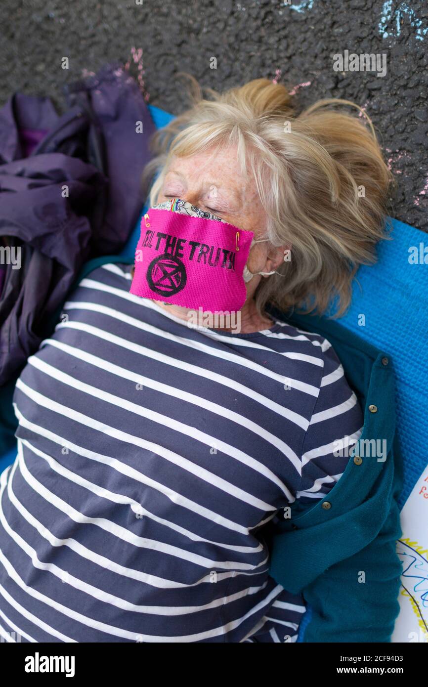 An elderly protester lying down blocking road during Extinction ...