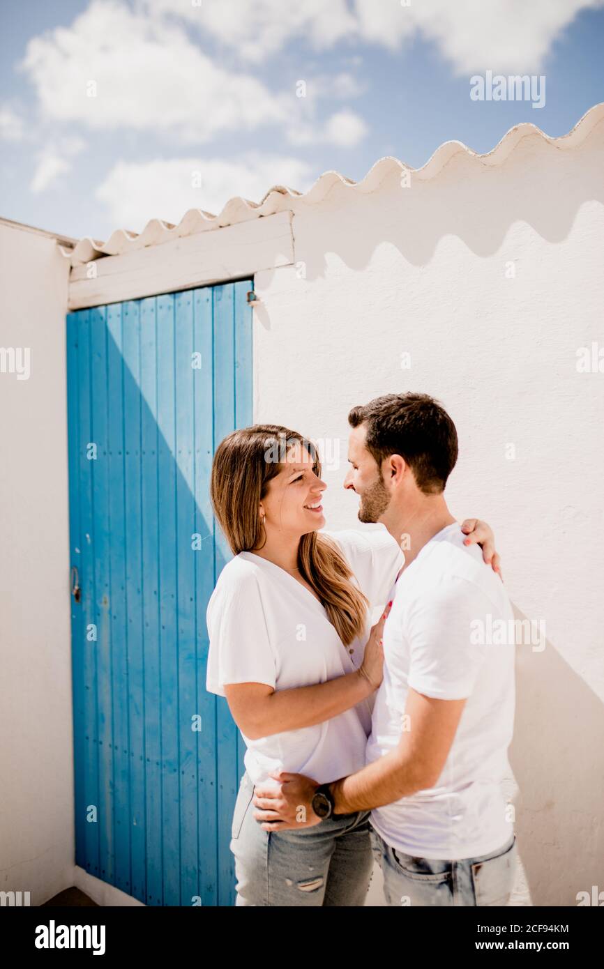 Loving couple cuddling near beach house Stock Photo - Alamy