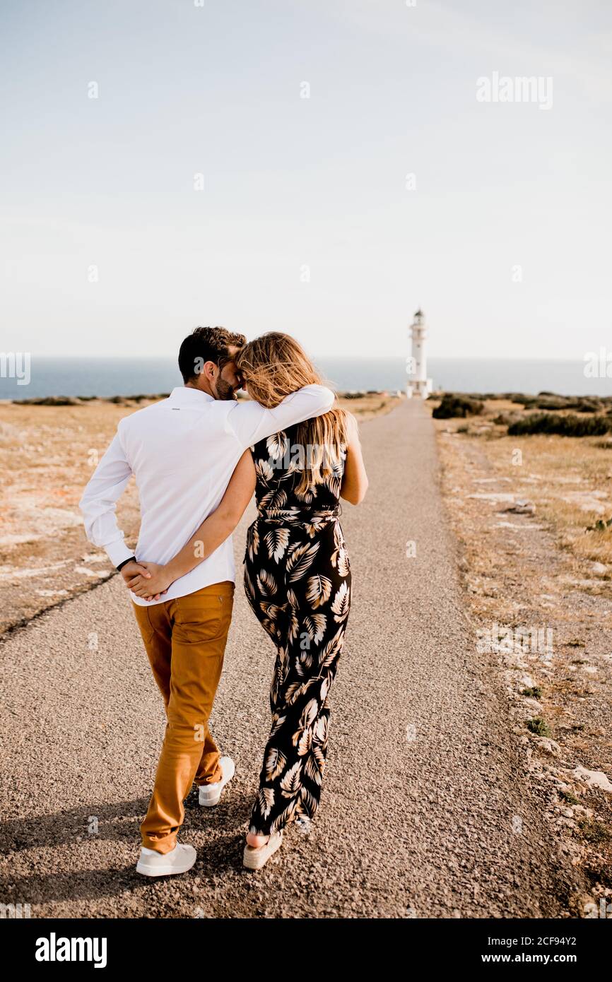Smiling lovers cuddling on path to sea Stock Photo - Alamy