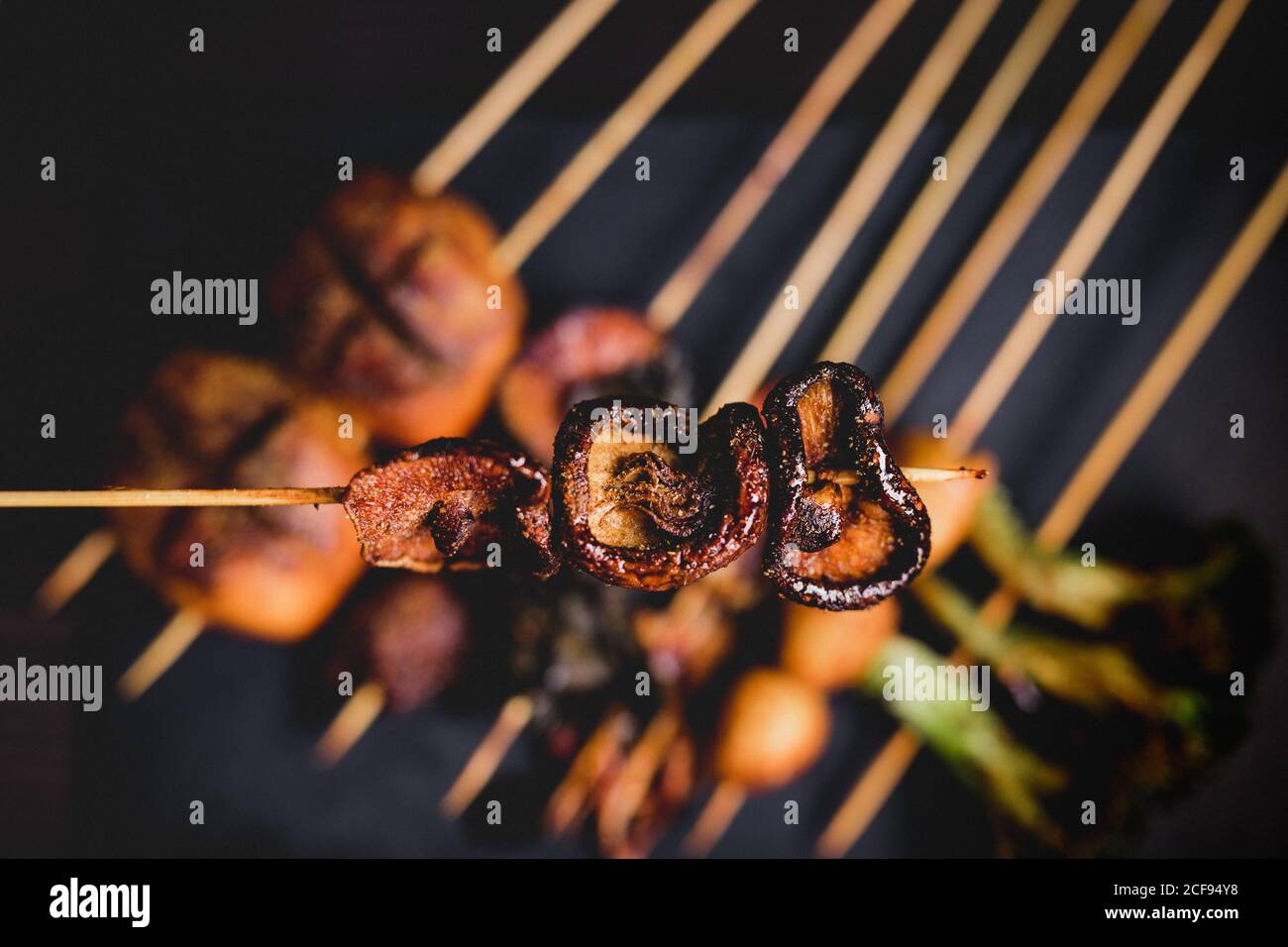 From above cooked hot mushroom skewer over table with delicious grilled ...