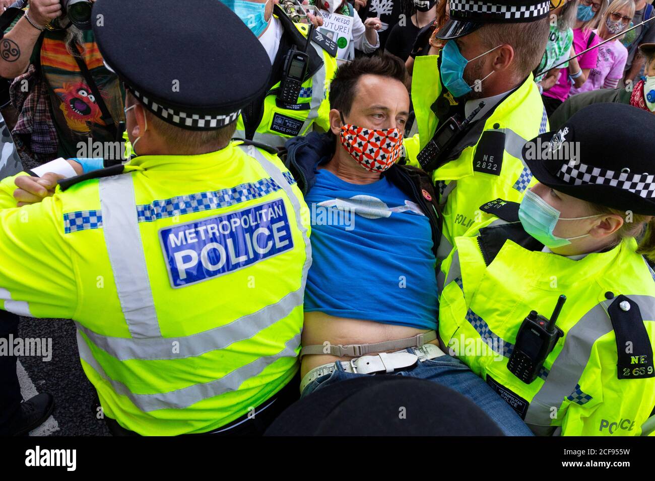 Arrested protester is carried off by police during Extinction Rebellion ...