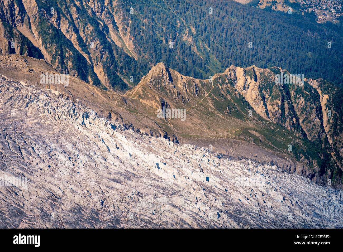 White sharp mountain peaks in snow raising up to cloudy sky Stock Photo ...
