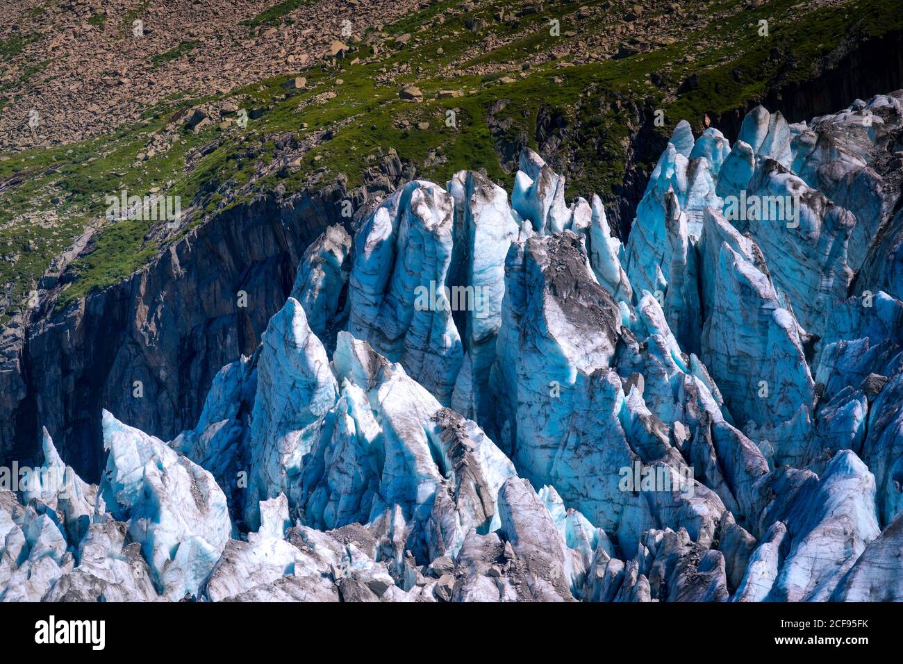 Sharp peak in snow and green mountains in bright day Stock Photo - Alamy