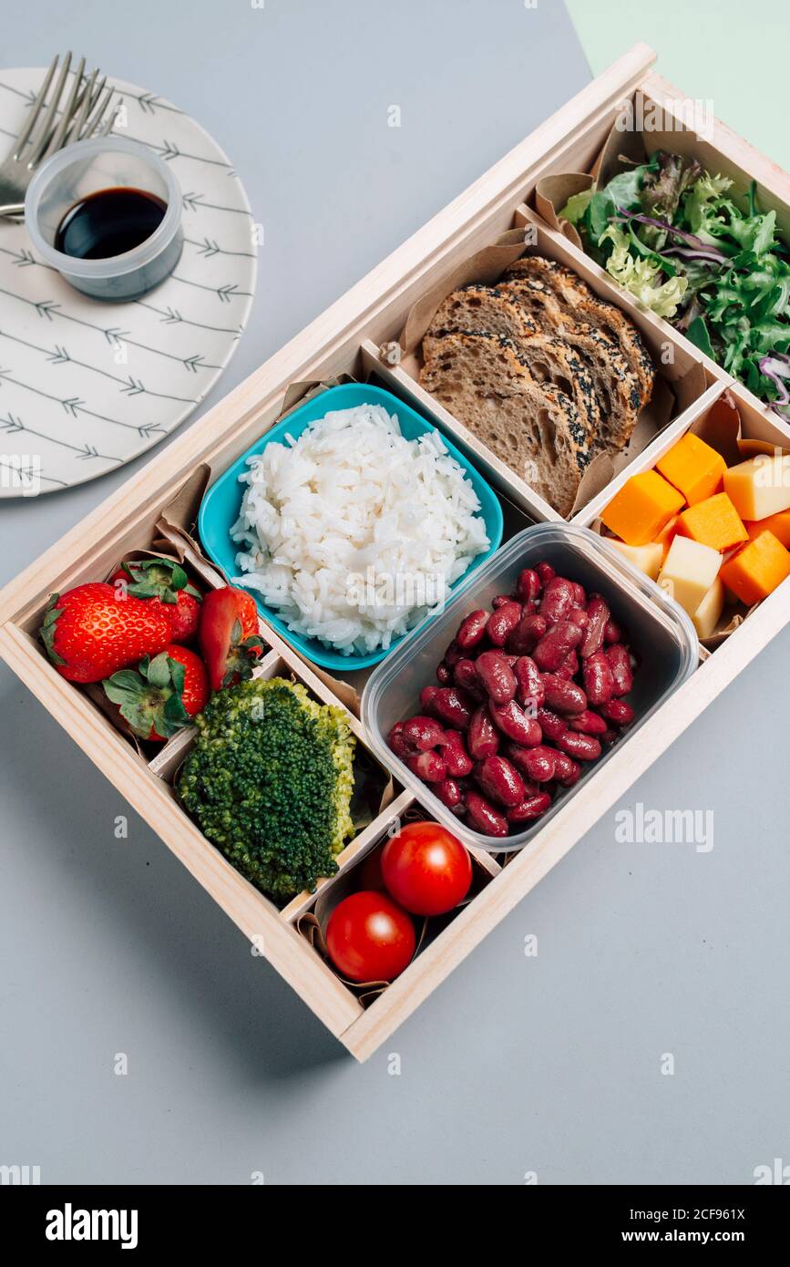 food box with diet ingredients by copybook and plate Stock Photo - Alamy