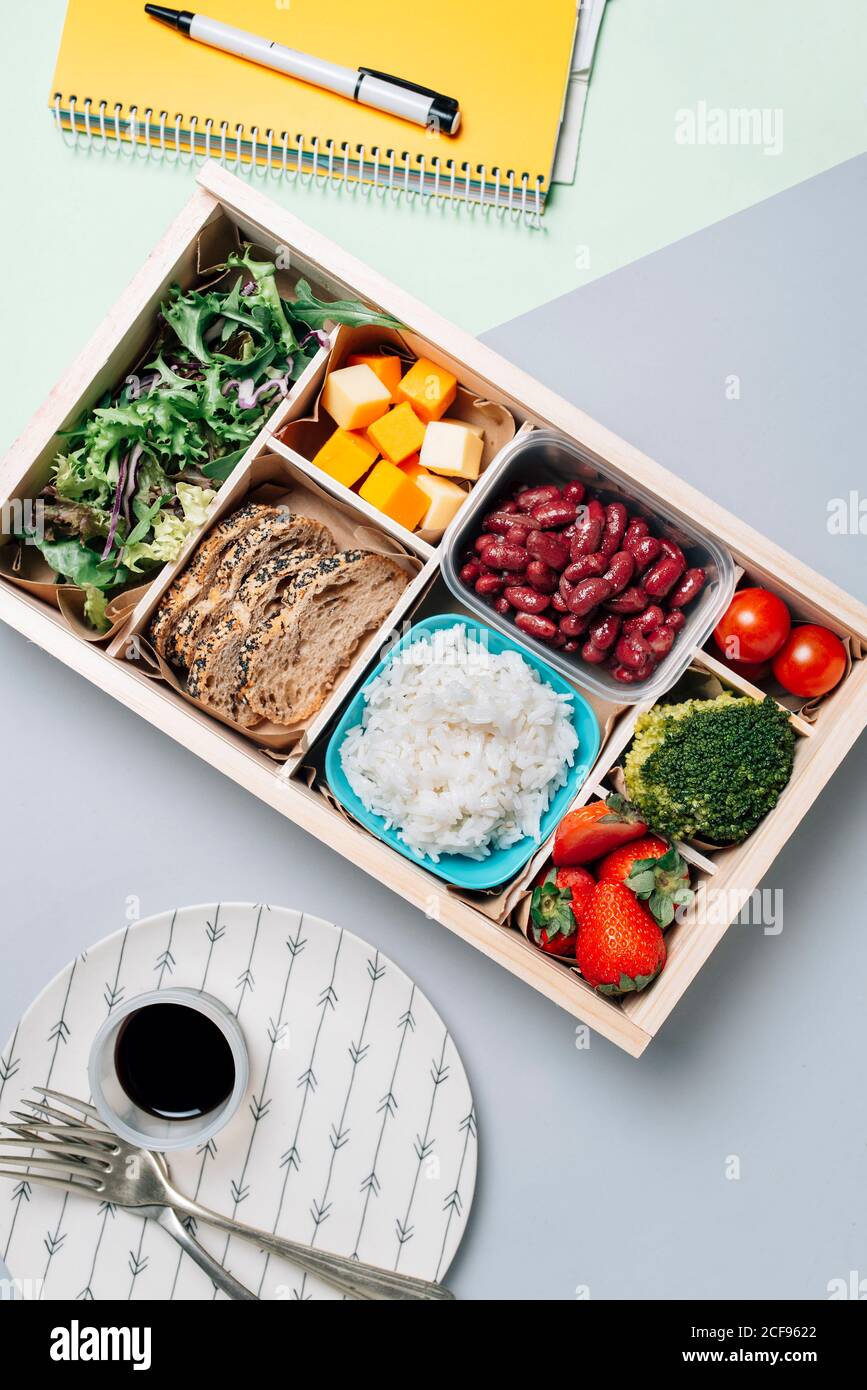 food box with diet ingredients by copybook and plate Stock Photo - Alamy