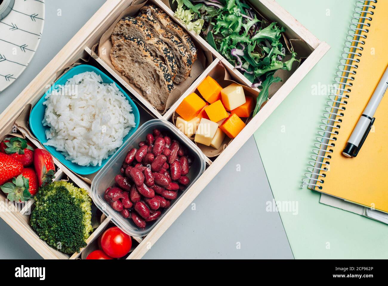 food box with diet ingredients by copybook and plate Stock Photo - Alamy