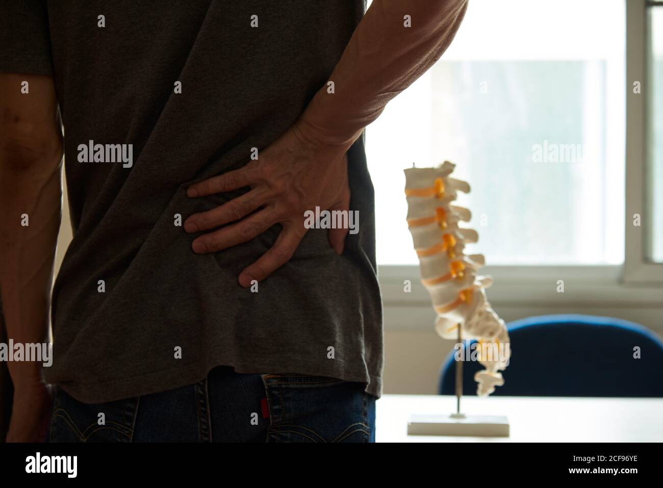 A male patient visiting medical clinic for low back pain. Lumbar ...