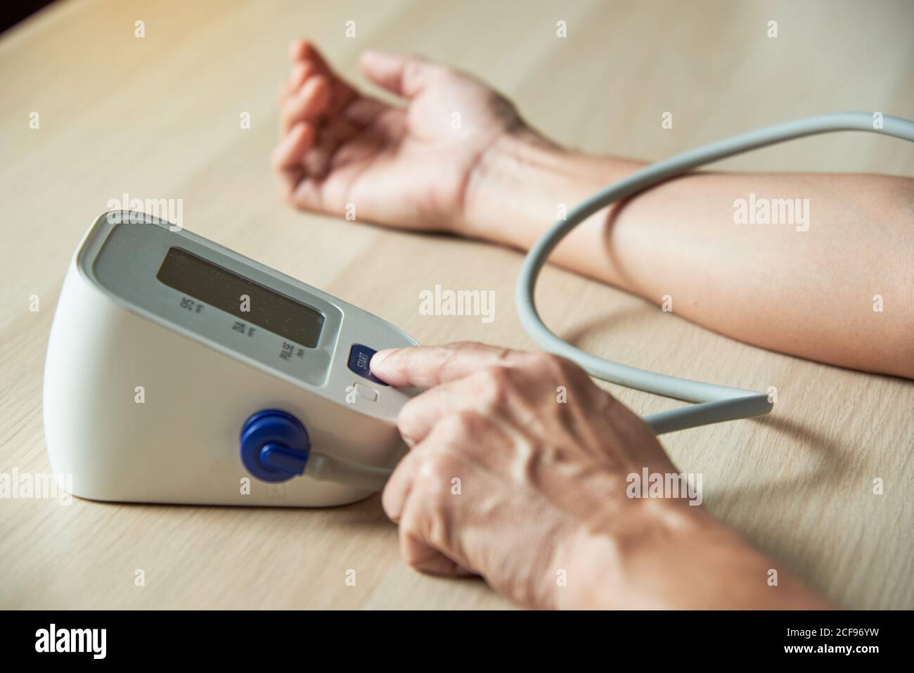 Close-up view of self measurement blood pressure using finger pressing ...