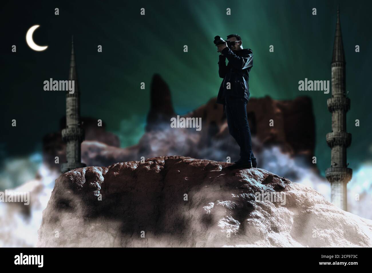 photographer on top of a ruined castle at night Stock Photo - Alamy