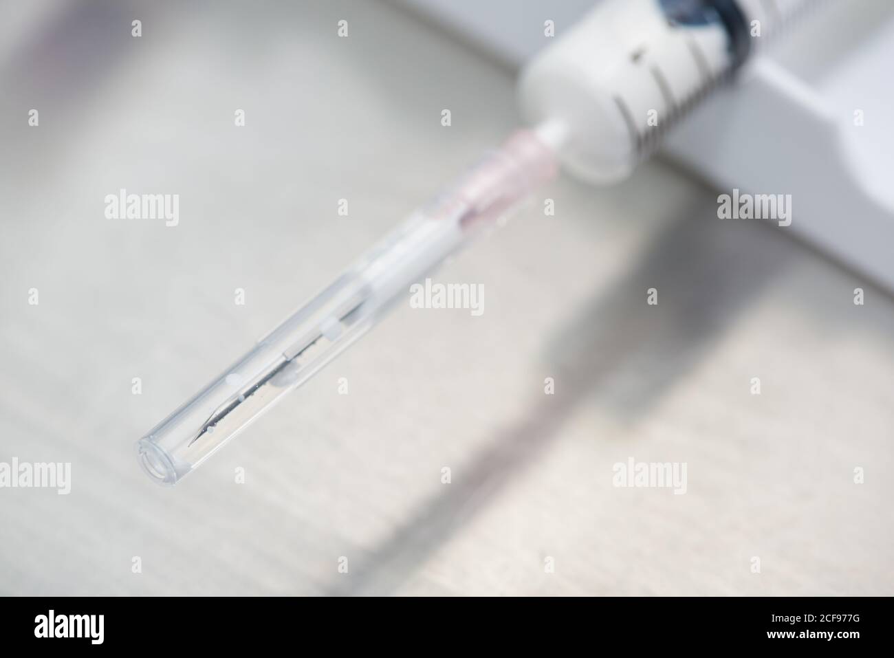 Needle on syringe with white medication on the rack in operating room ...