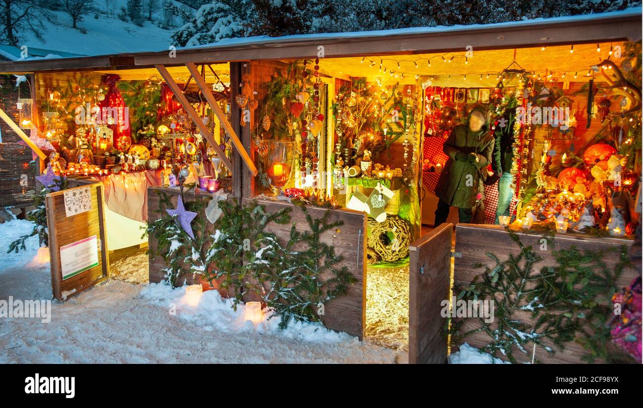 Romantic Christmas market with illuminated shops in wooden huts with ...