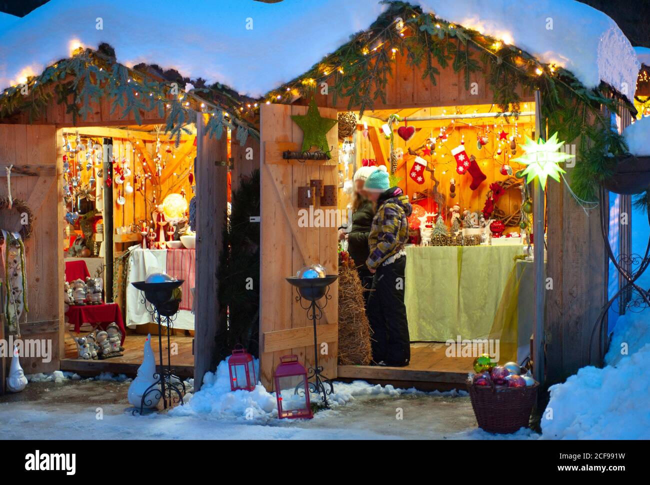 Romantic Christmas market with illuminated shops in wooden huts with ...