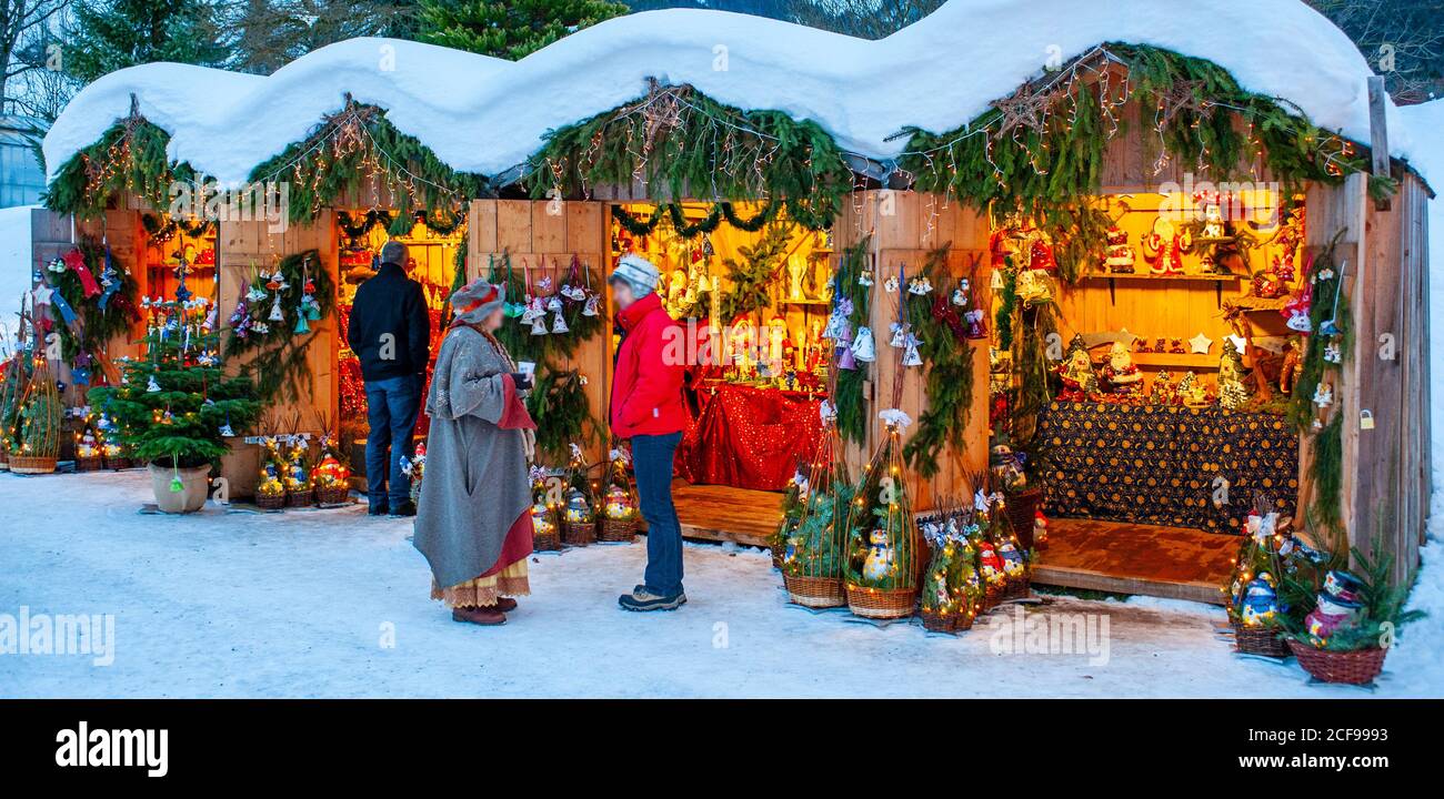 Romantic Christmas market with illuminated shops in wooden huts with ...