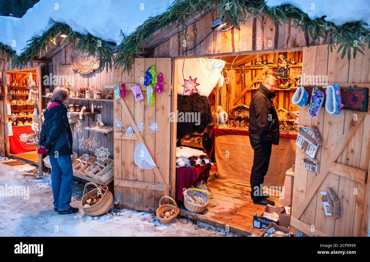 Romantic Christmas market with illuminated shops in wooden huts with ...