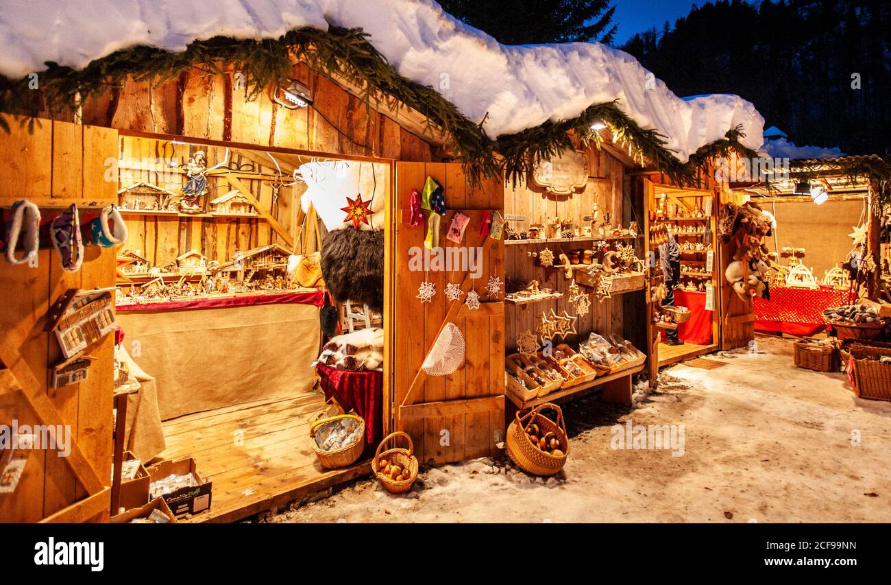 Romantic Christmas market with illuminated shops in wooden huts with ...