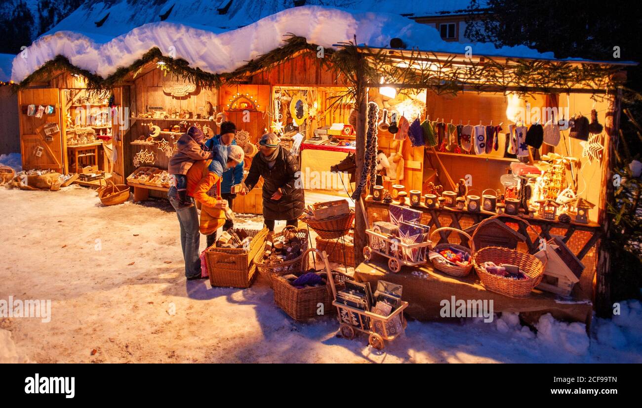 Romantic Christmas market with illuminated shops in wooden huts with ...