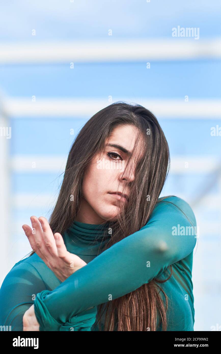 Low angle side view of young independent female dancer looking at ...