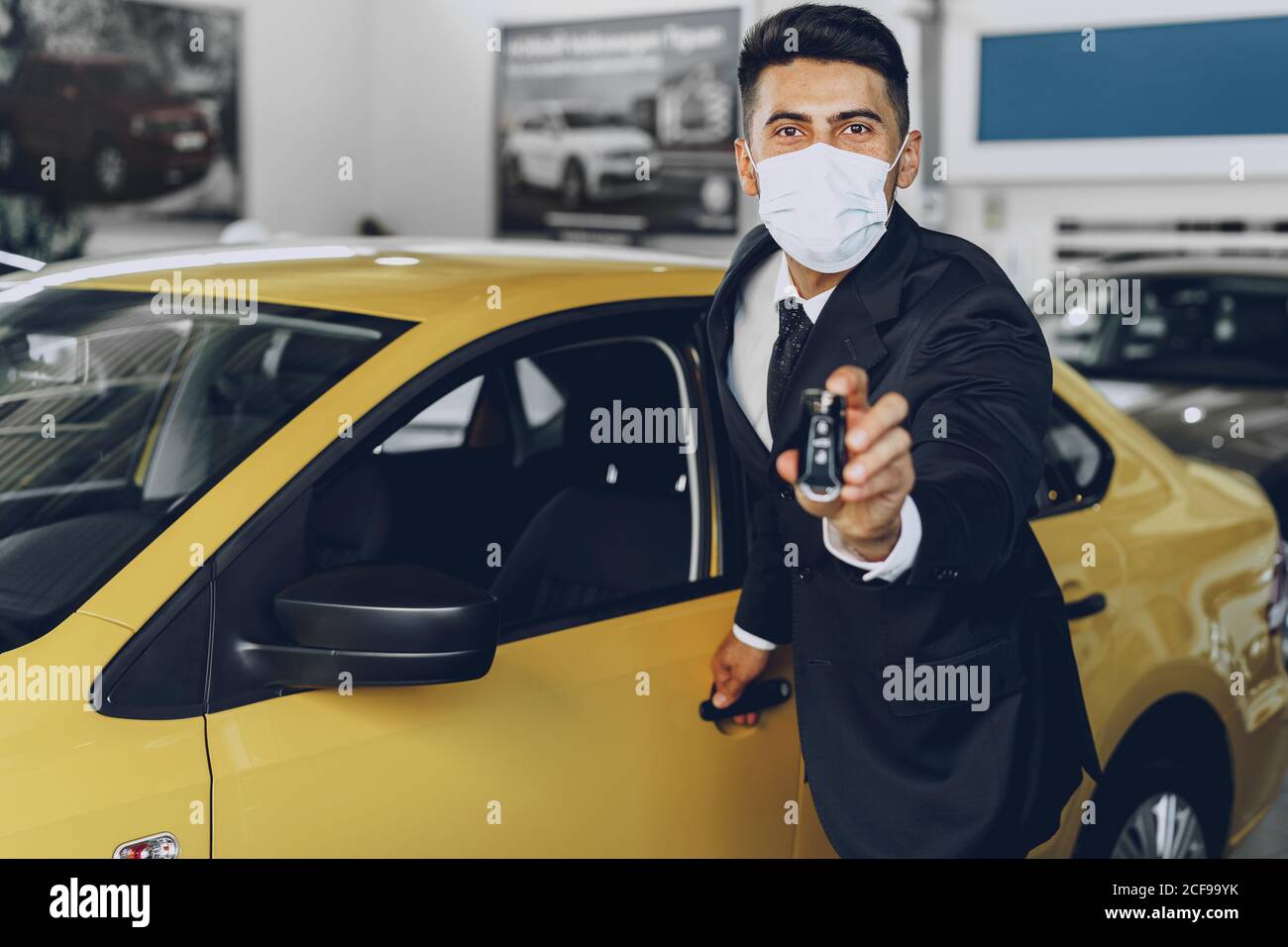 Man car dealer wearing protective medical mask on his working place ...