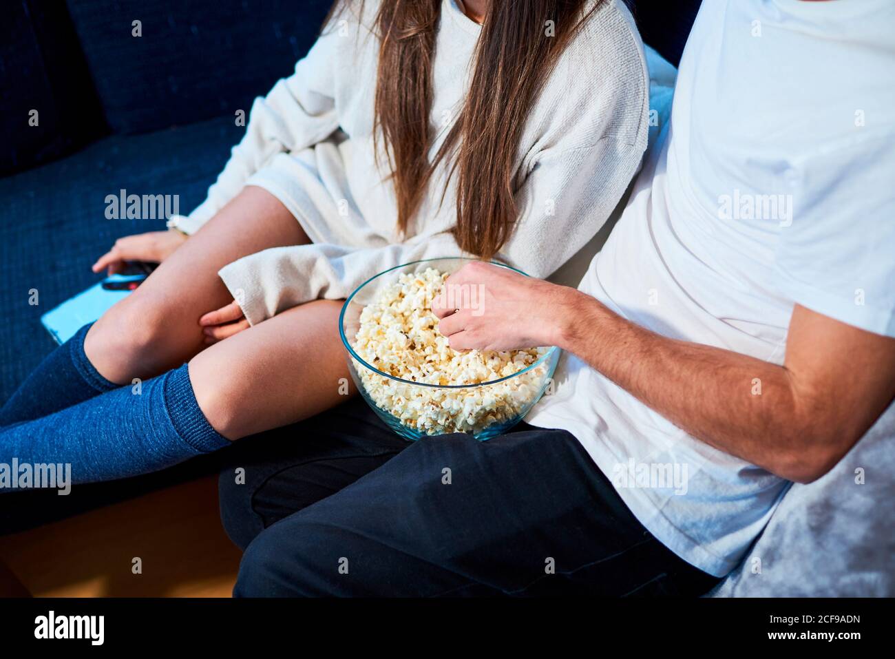 Couple eating popcorn on sofa hi-res stock photography and images - Alamy
