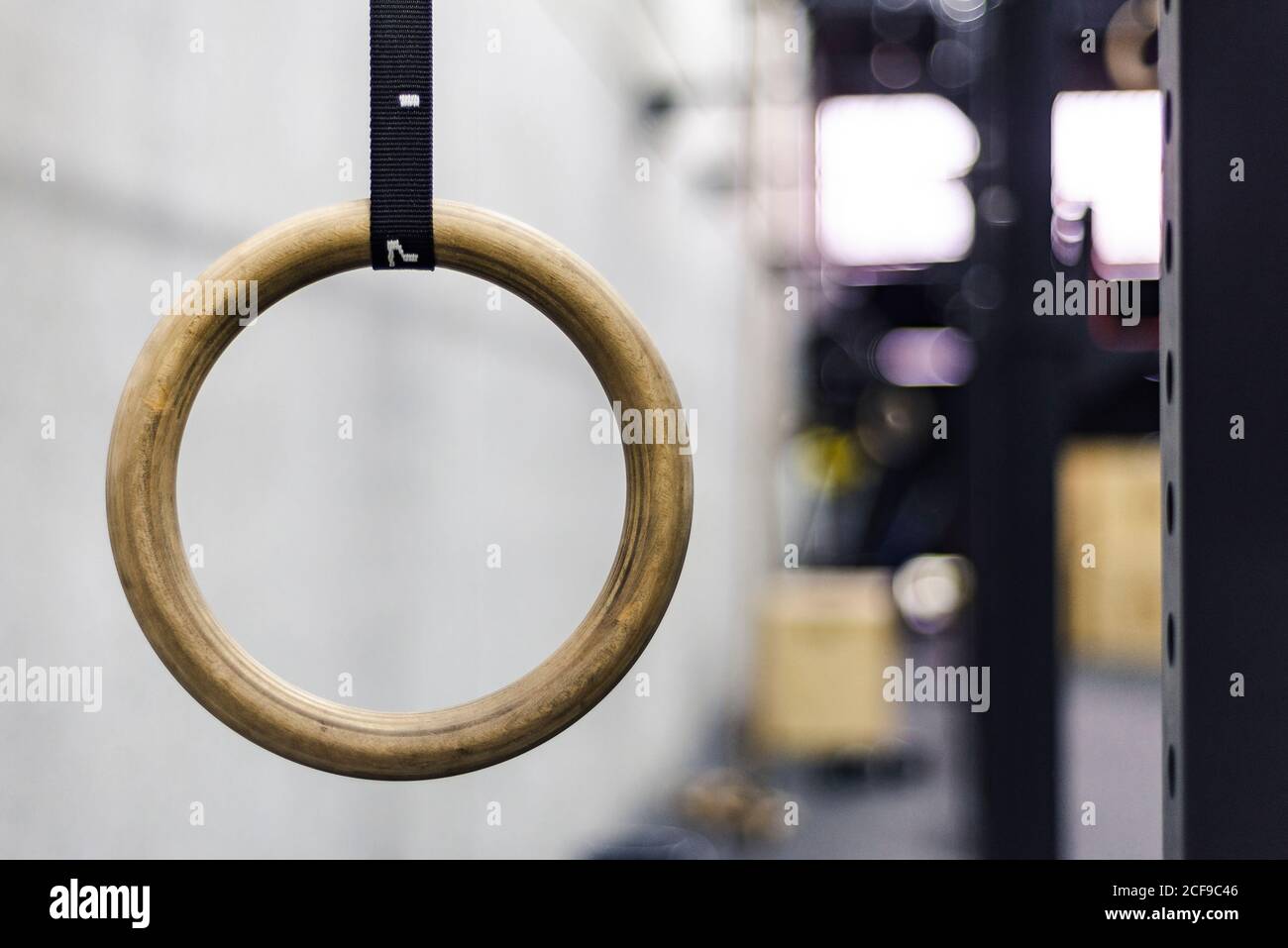 Gymnastic ring hanging in gym on blurred background Stock Photo - Alamy