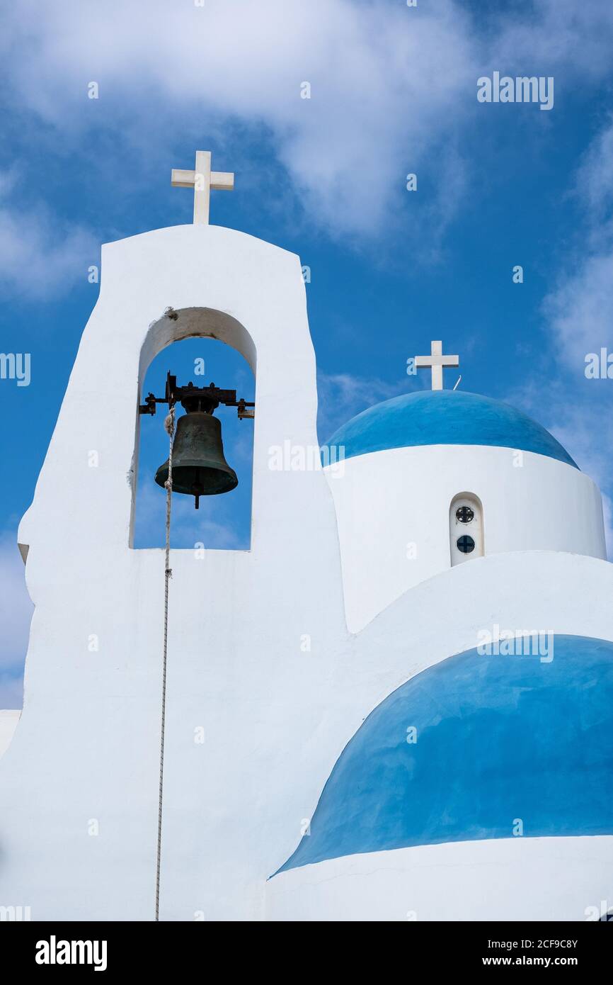 Traditional small christian church with belfry dome against blue cloudy ...