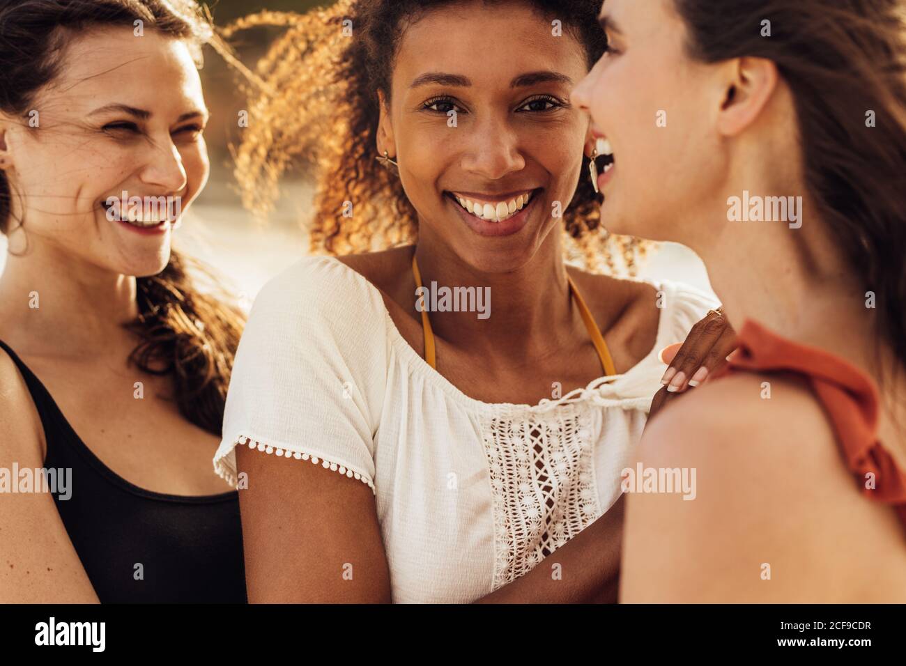 Close up of three women friends standing outdoors. Cropped shot of ...