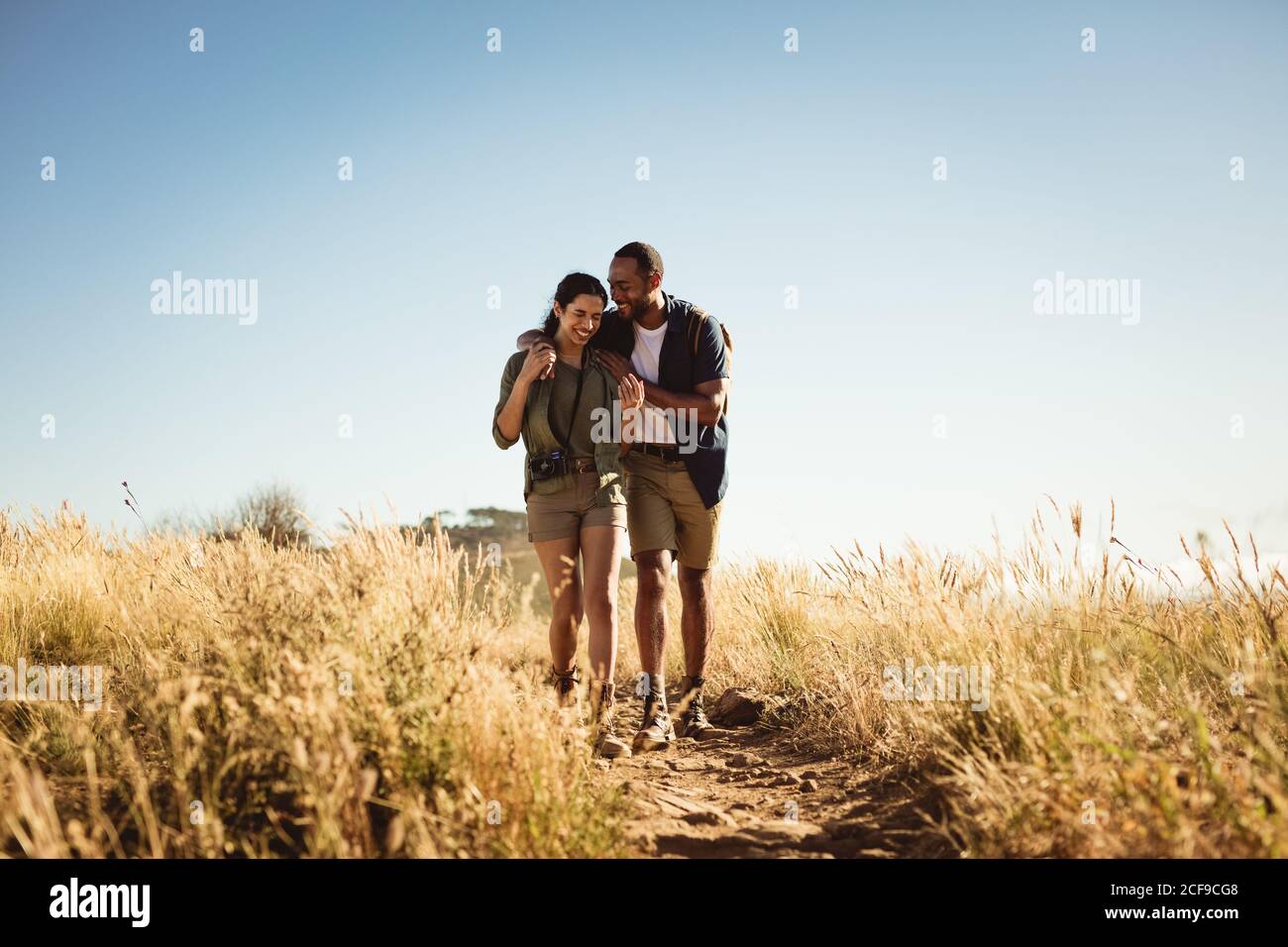 Happy couple having fun on a hiking trip. Tourist couple walking on a ...