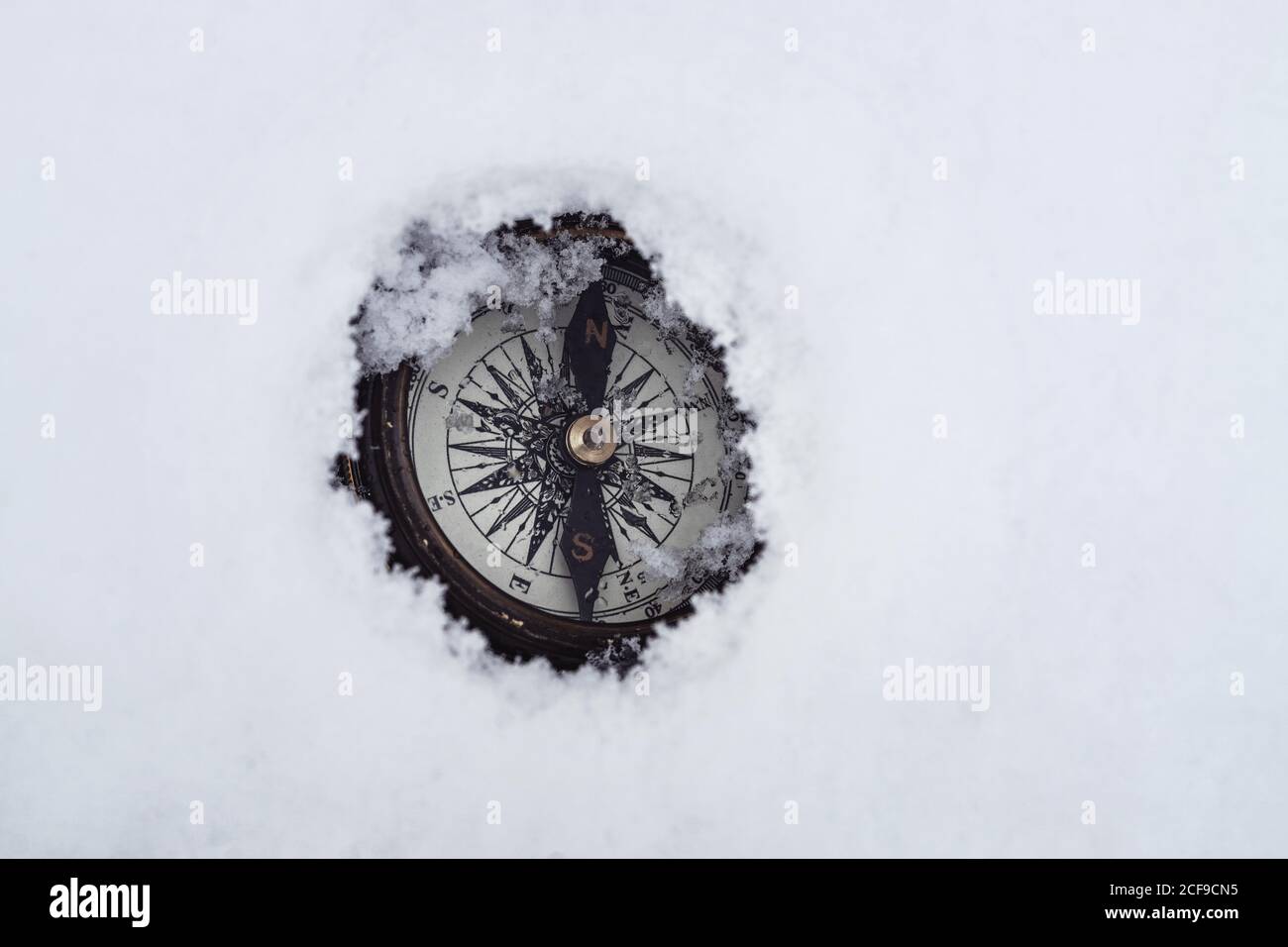 Compass covered with snow Stock Photo - Alamy