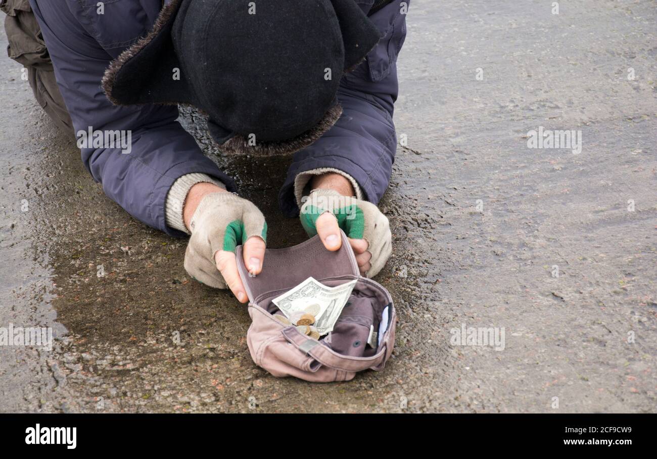 Homeless beggar asks for alms on the bridge.Beggar begging on the ...