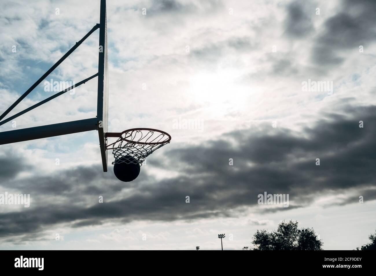ball into basket in Outdoor basketball court and black ball Stock Photo ...