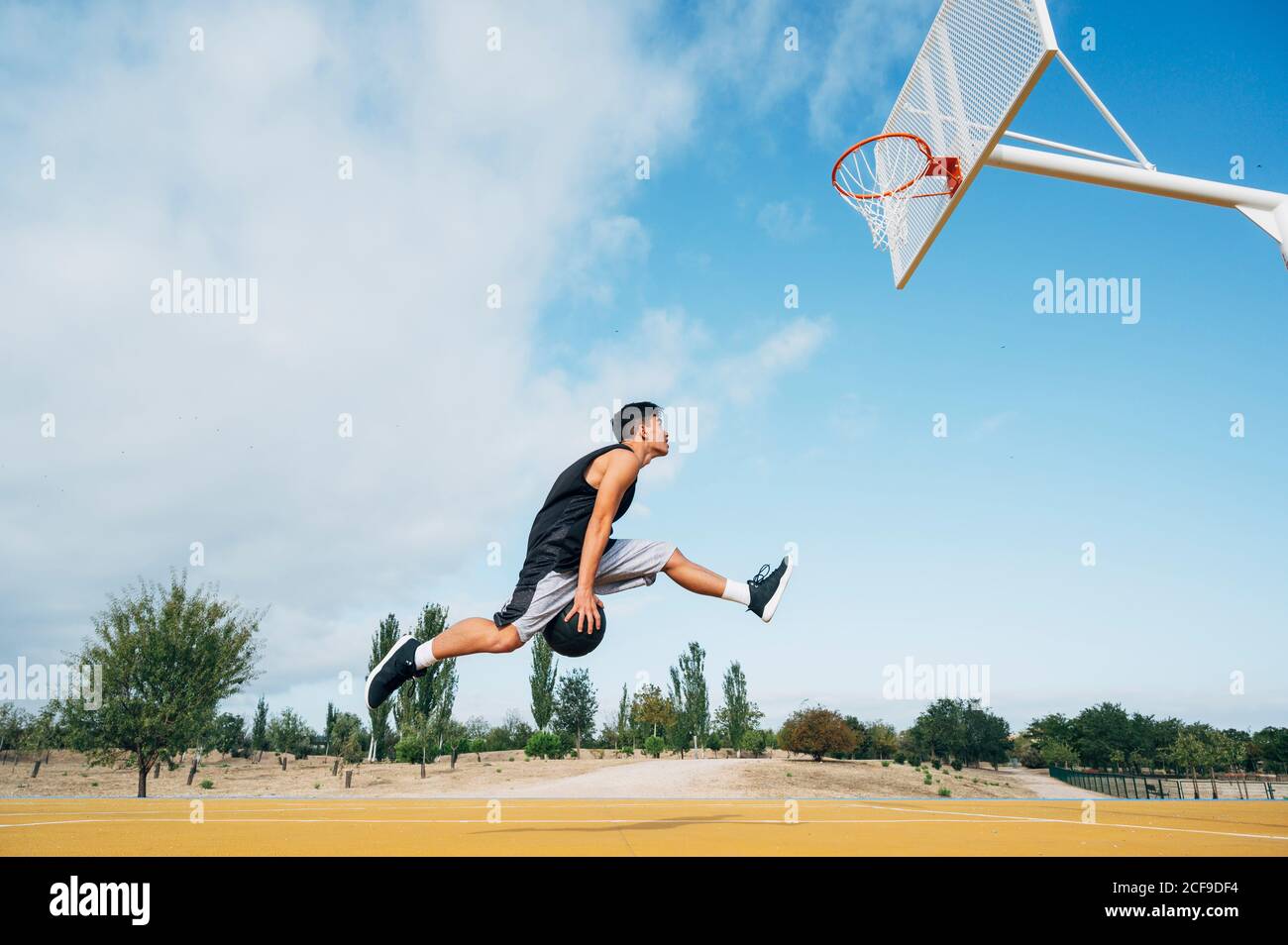 Young man playing on basketball court outdoor Stock Photo - Alamy